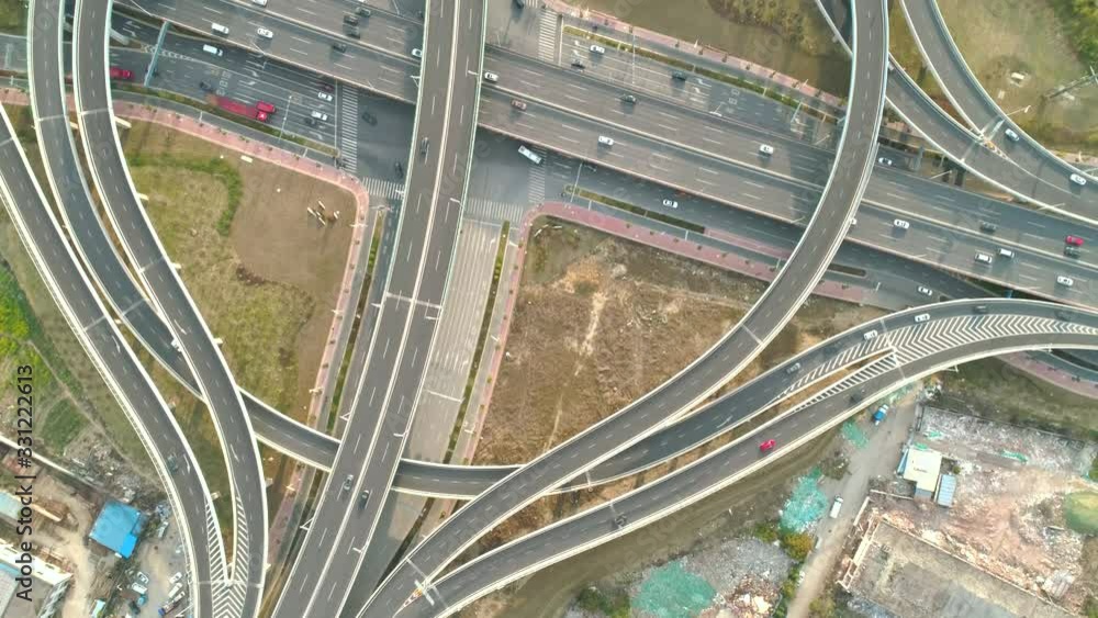 Top view to the cars driving on multi-level highway on the sunset ...