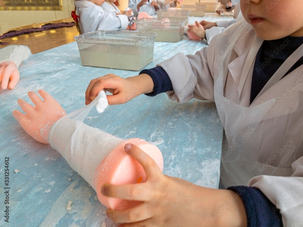 Preschooler, child studying first aid. Little doctor in medical uniform ...