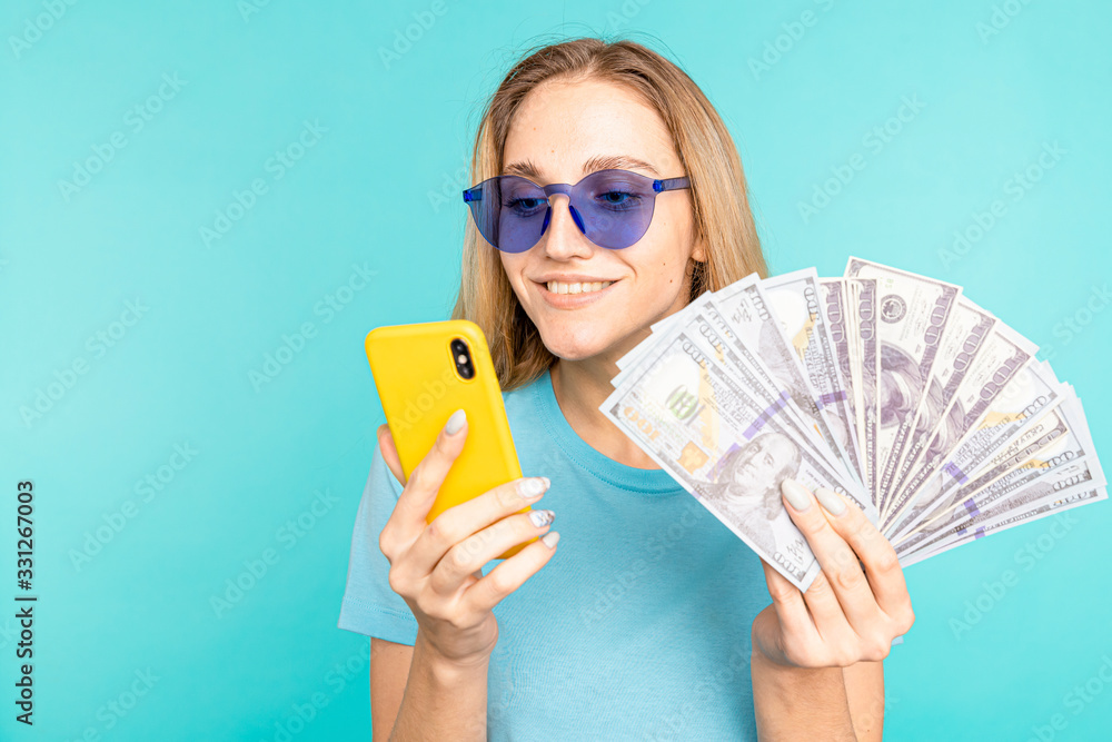 young lady isolated over blue background. Looking camera showing ...