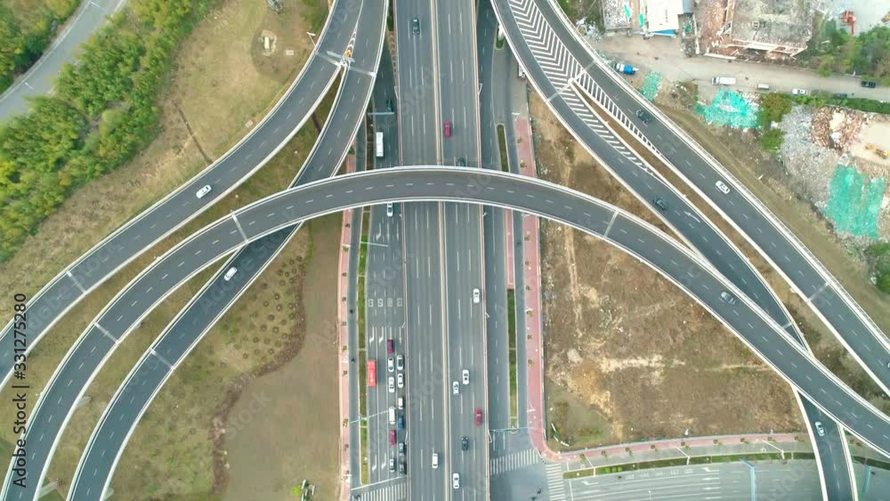 Top view to the cars driving on multi-level highway on the sunset ...