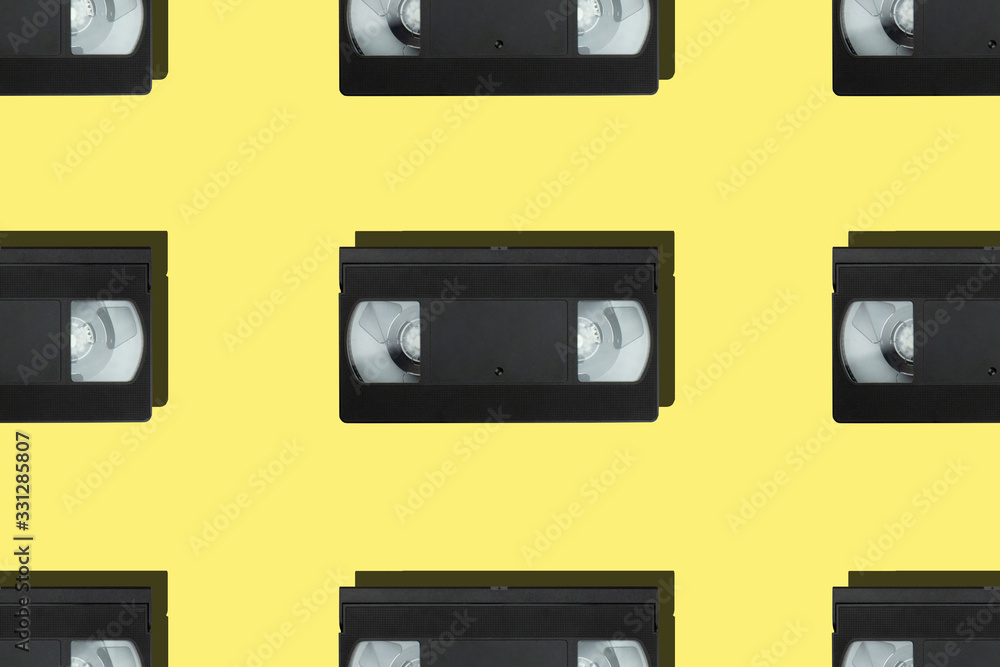 Seamless pattern with retro vhs tapes flat lay on colorful yellow ...