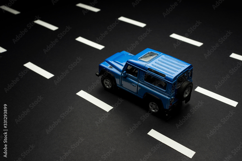 Blue Suv which is an old fashioned style on a black background and with ...