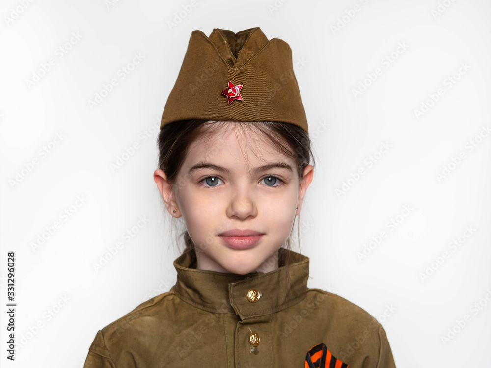 Close-up portrait of a beautiful little russian smiling girl in uniform ...