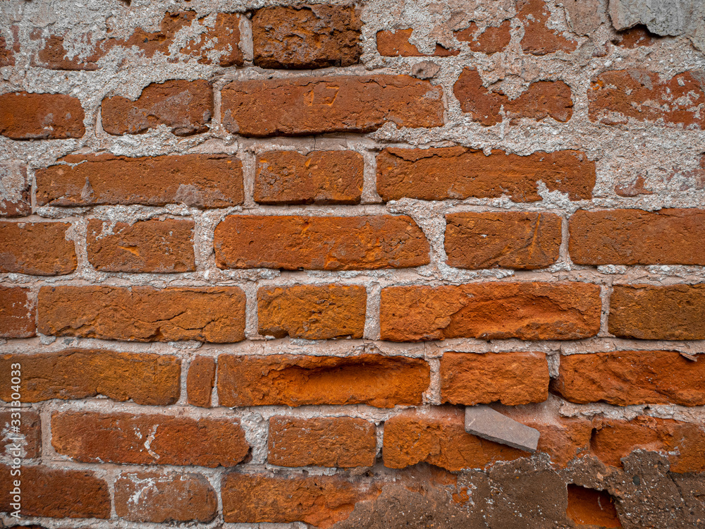 Old red grunge brick wall looks like texture. Close-up view of the ...