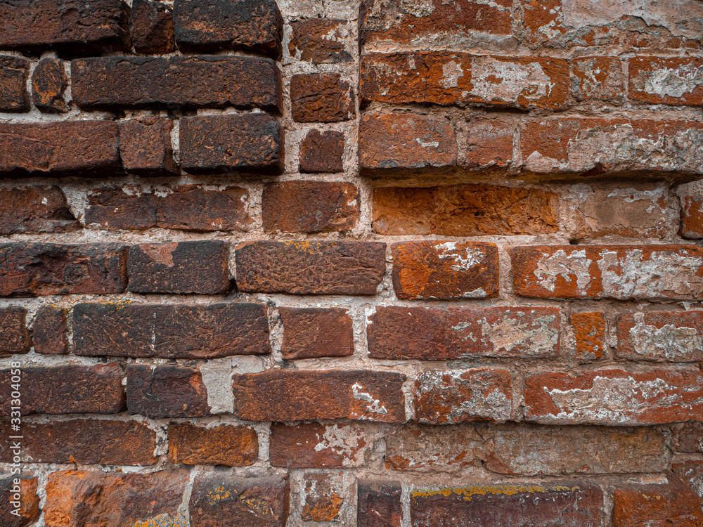 Old red grunge brick wall looks like texture. Close-up view of the ...