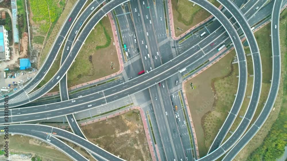 Top view to the cars driving on multi-level highway on the sunset ...