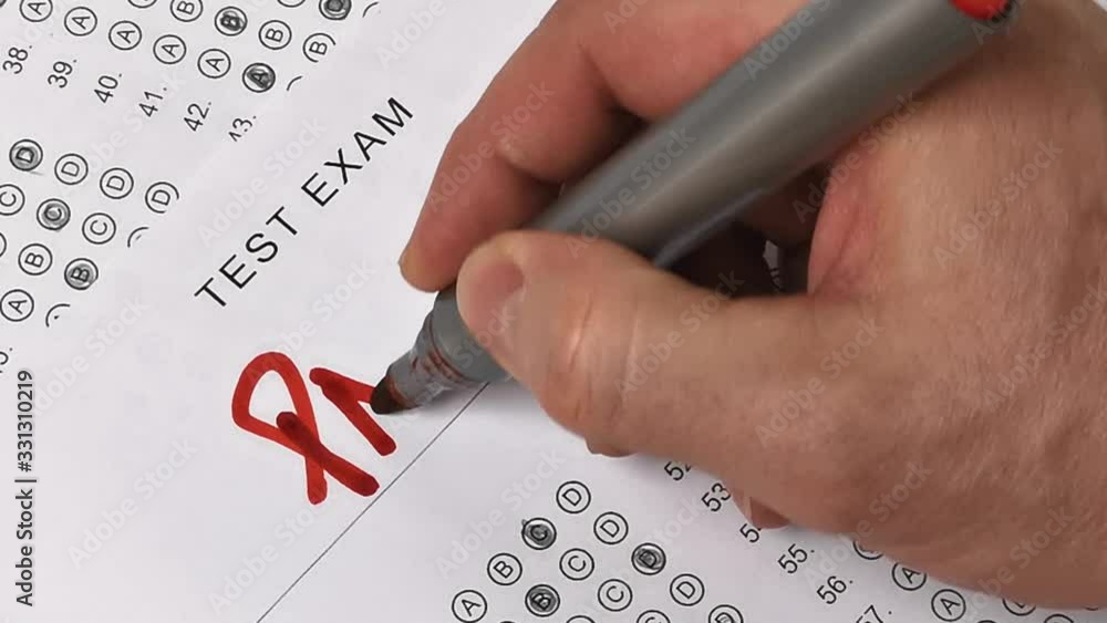 teacher writing a plus on multiple choice test Stock Video | Adobe Stock