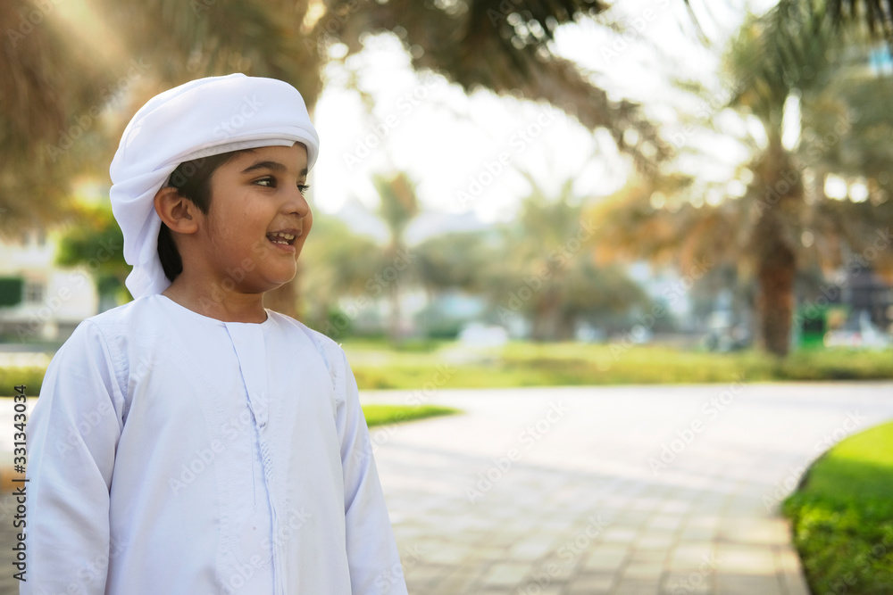 Young Arab boy national wearing traditional wear while in side view ...