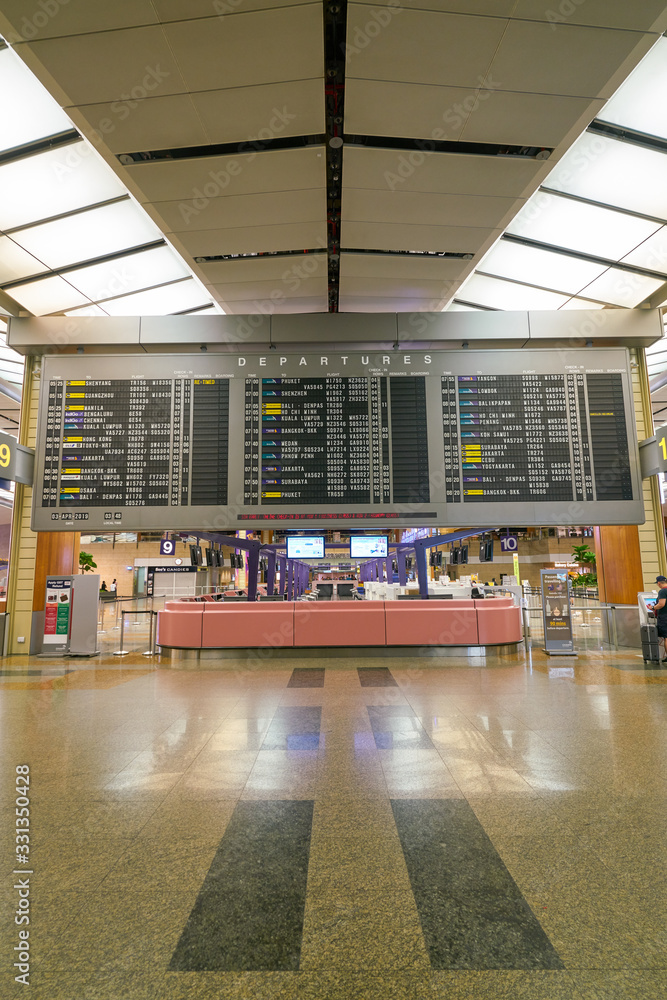SINGAPORE - CIRCA APRIL, 2019: a flight information display at ...