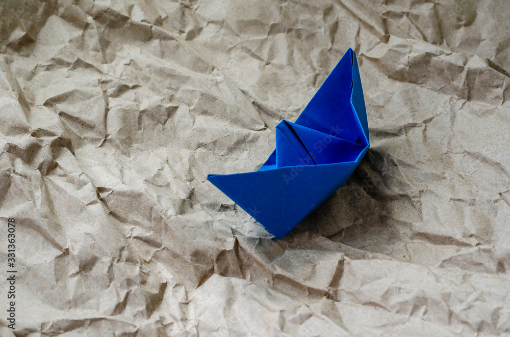 Blue paper boat - a symbol of hope. Stock Photo | Adobe Stock