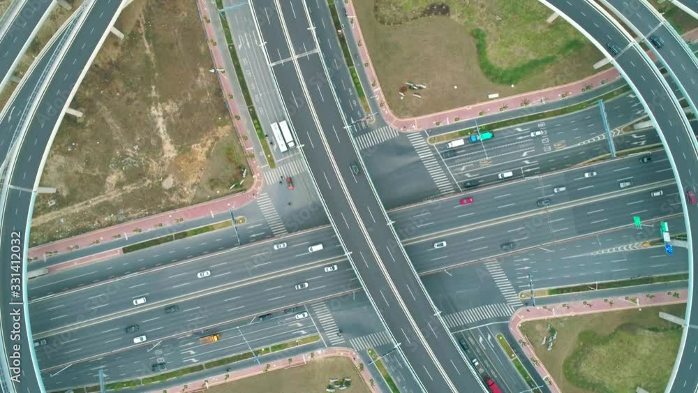 Top view to the cars driving on multi-level highway on the sunset ...