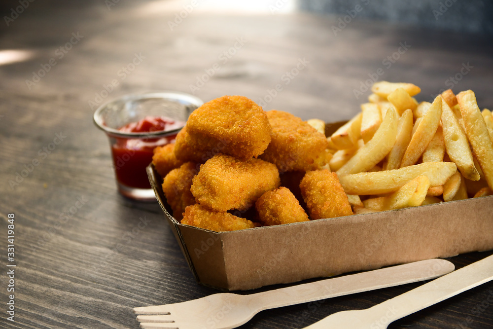 food delivery service. hot chicken nuggets and fries. take out food in ...