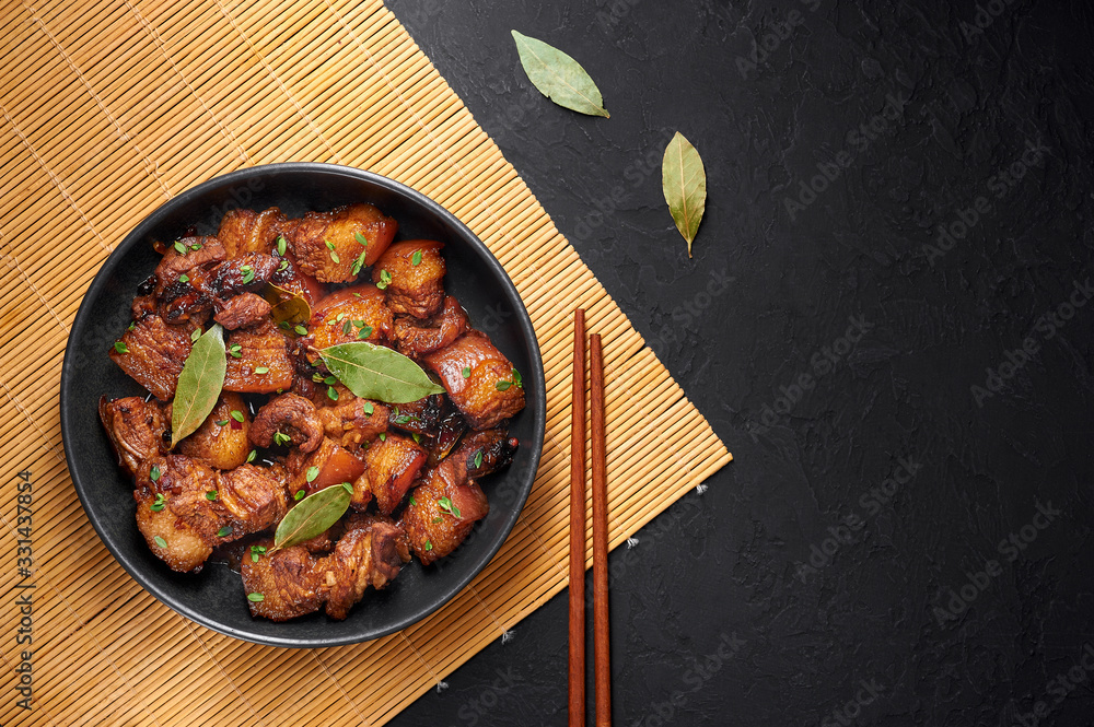 Foto de Adobo Pork in black bowl at dark slate background. Pork Adobo ...