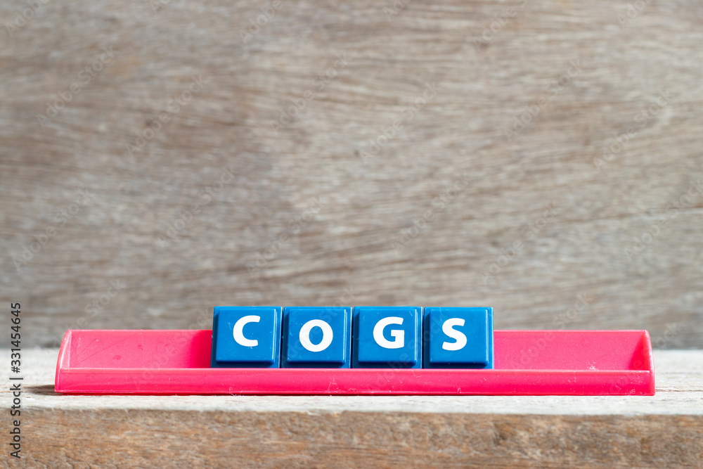 Tile letter on red rack in word COGS (Abbreviation of Cost of goods ...