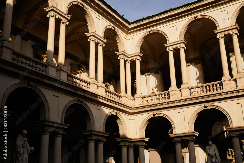Yard of historical medieval building with columns in touristic city ...