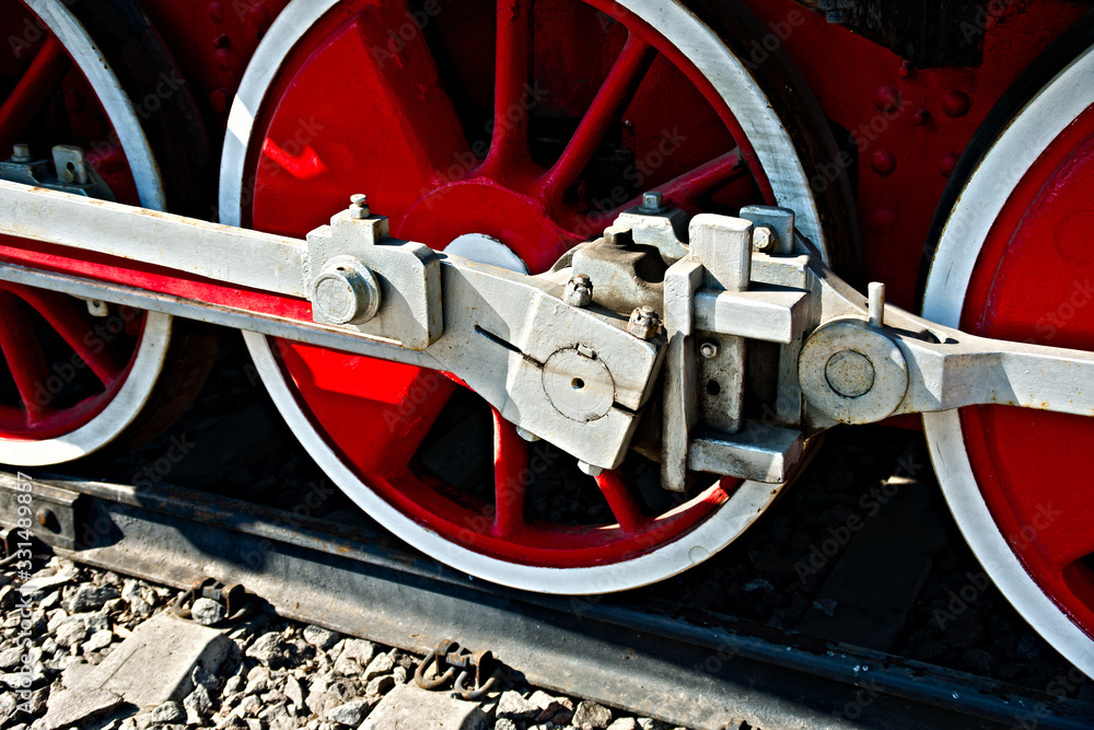 Red driving wheels of a vintage steam engine locomotive. Driving rods ...