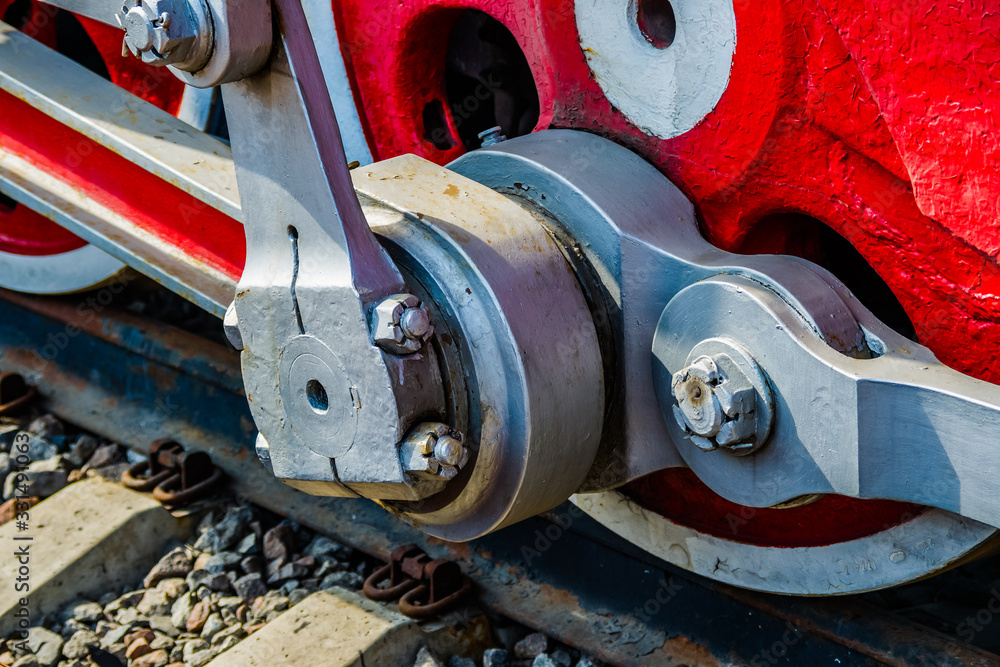 Metal parts and details of driving wheels of a vintage steam engine ...