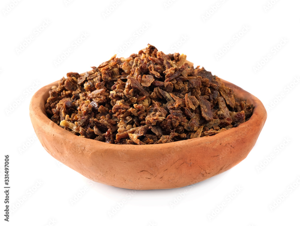 Granules of bee propolis in a clay bowl on a white background. Propolis ...