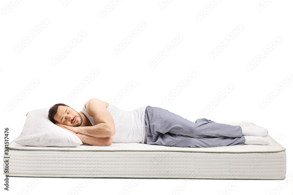 Young man sleeping on a comfortbale mattress isolated on white ...