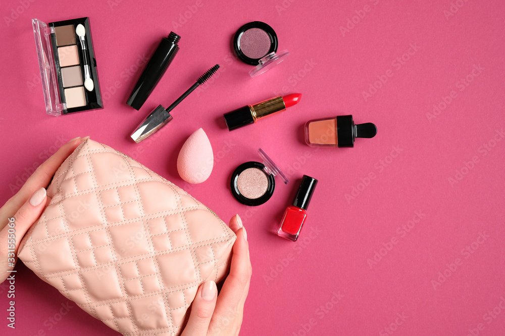 Make-up cosmetic bag in female hands on pink background. Glamour makeup ...