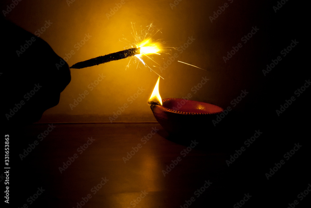 Person burning crackers on Diwali, Diwali Stock Photo | Adobe Stock