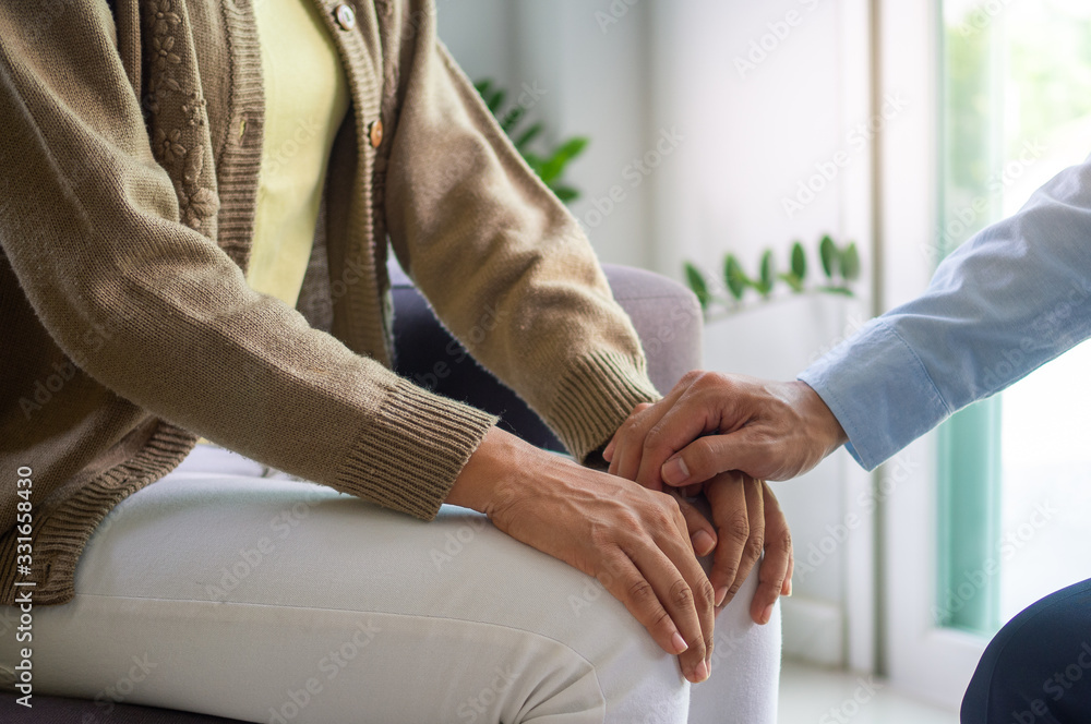 Woman and man sitting on couch two people holding hands. Symbol sign sincere feelings ...