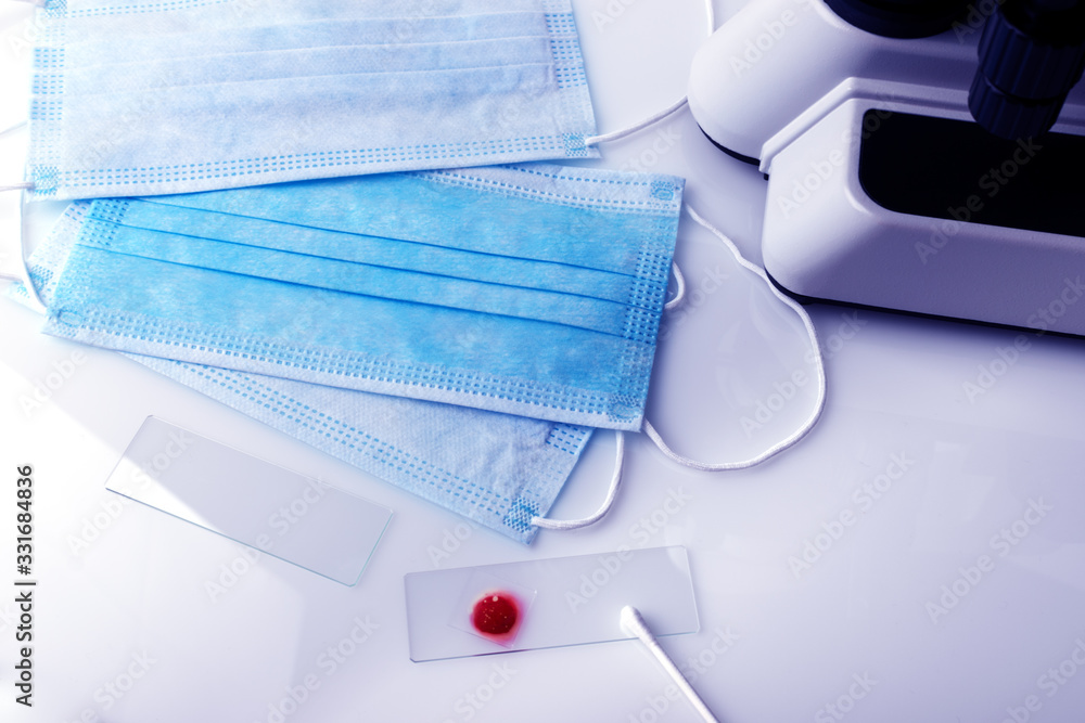 Blood analysis on a laboratory table, glass slide with blood sample ...