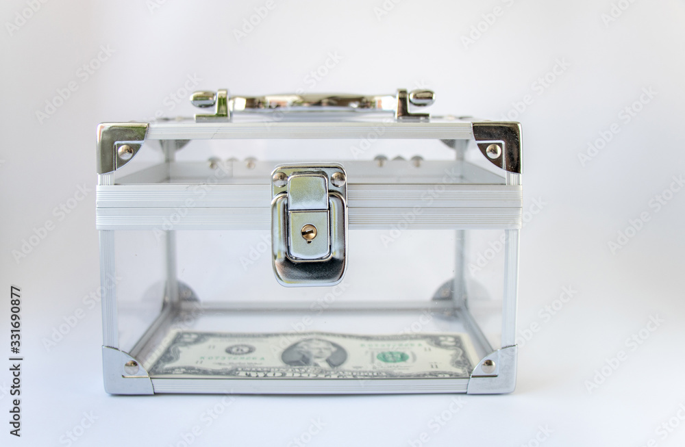 Dollar bill in a glass steel transparent case on a white background ...