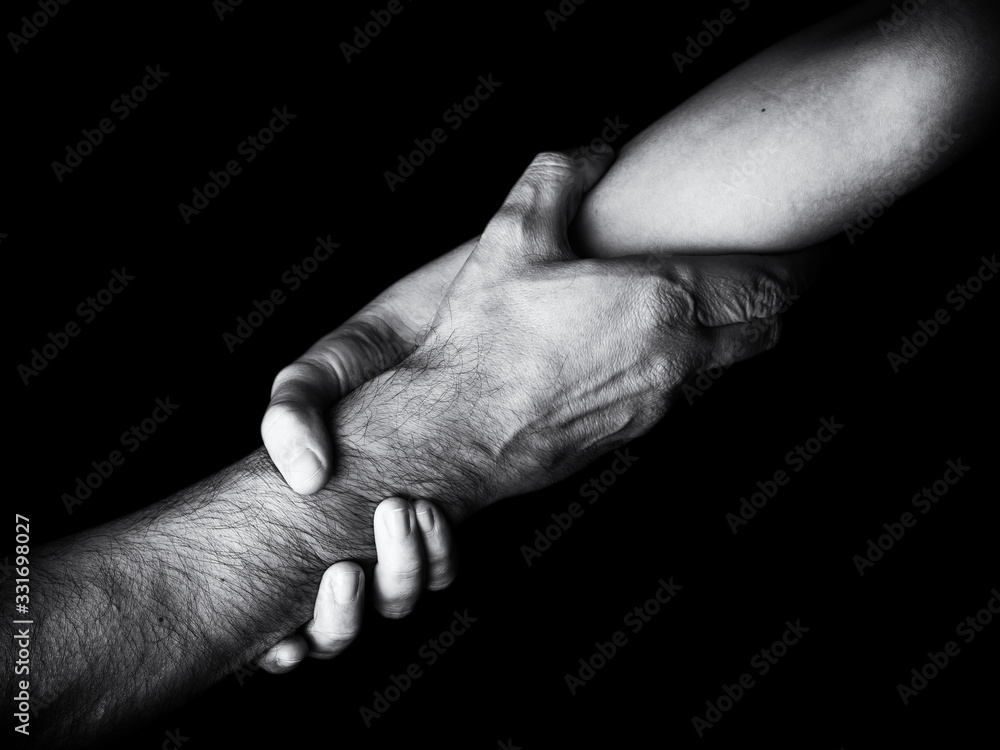 Woman saving rescuing and helping man by holding or griping hand ...