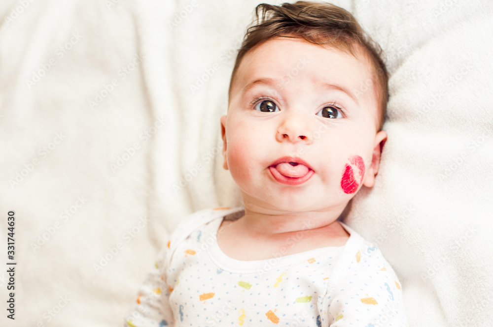 cute newborn baby with lipstick mark in his cheek Stock Photo | Adobe Stock