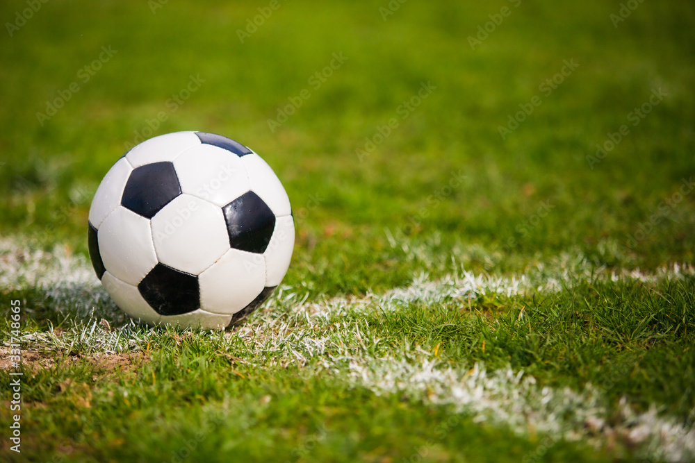 Classic soccer ball in sunset with typical black and white pattern ...