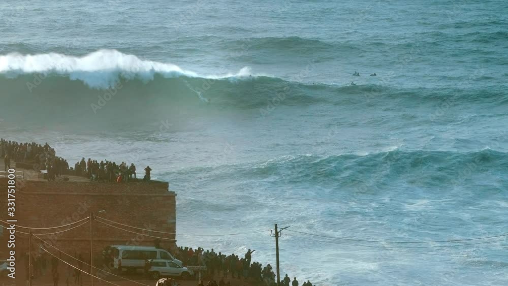 NAZARE, PORTUGAL - DECEMBER 22, 2019: Amazing shot of a jetski pushing ...