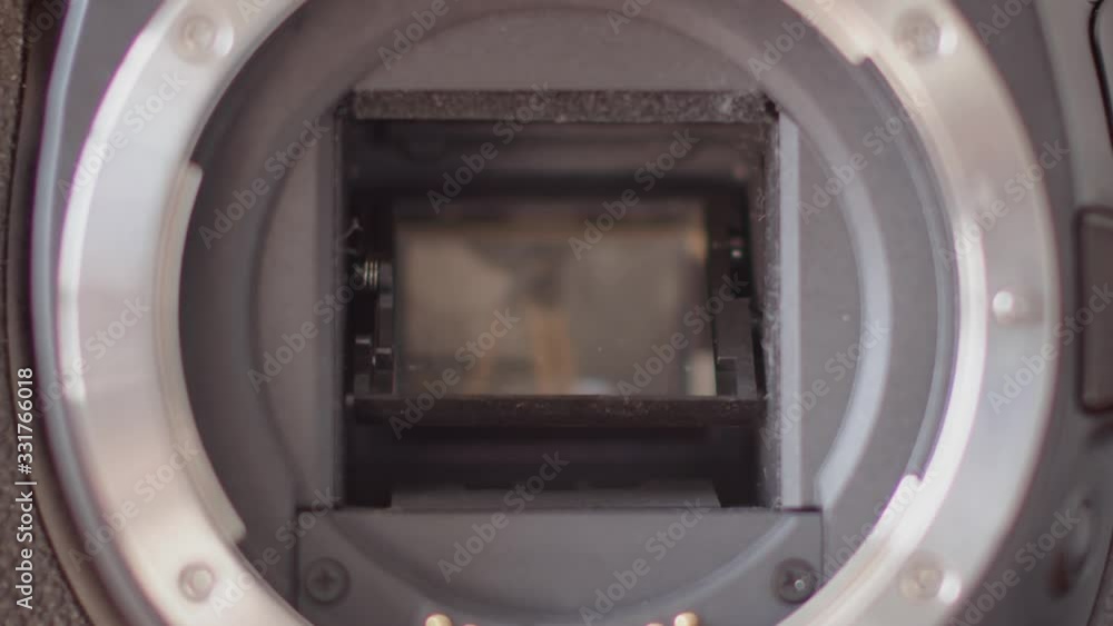 Close-up of the camera shutter opening. Opening the camera matrix ...