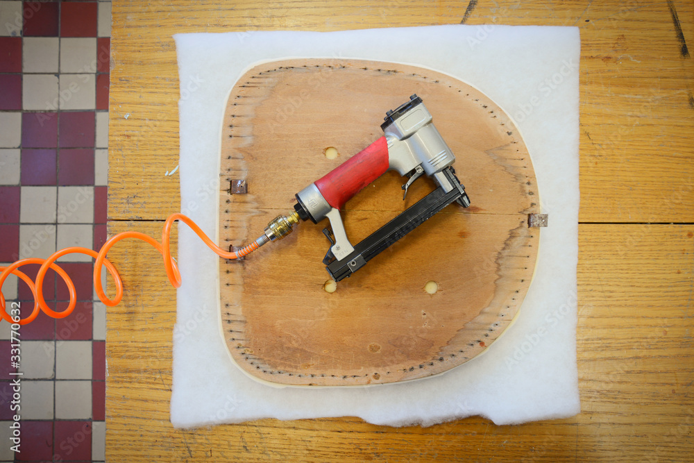 Upholstery workshop. Table top view. Work on upholstered chair seat ...
