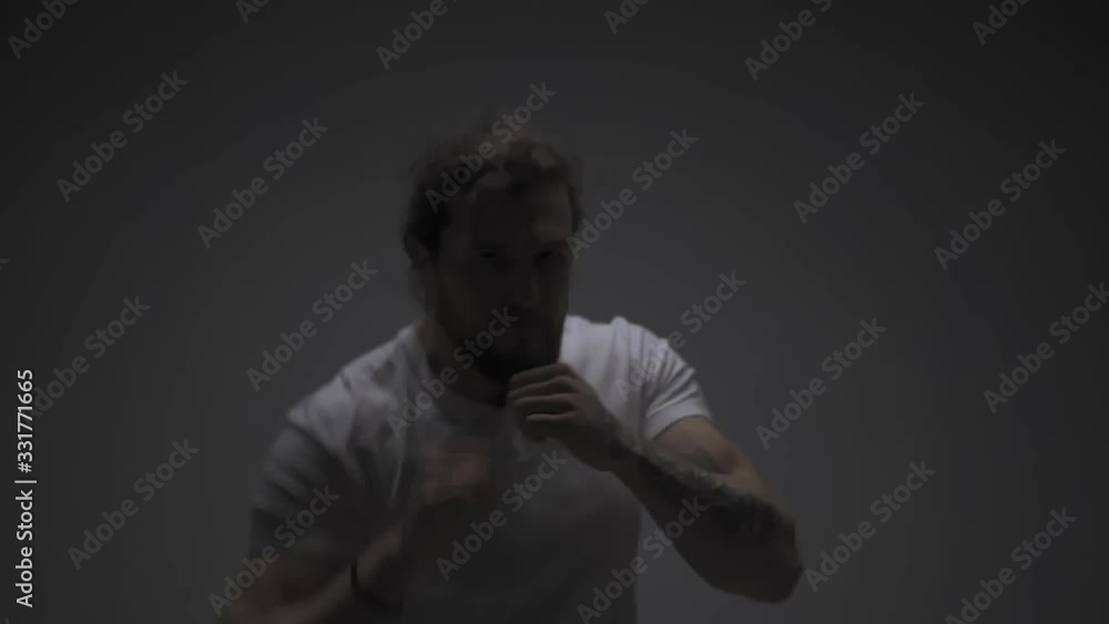 Fitness man fighting with camera indoor workout. Close up male athlete ...