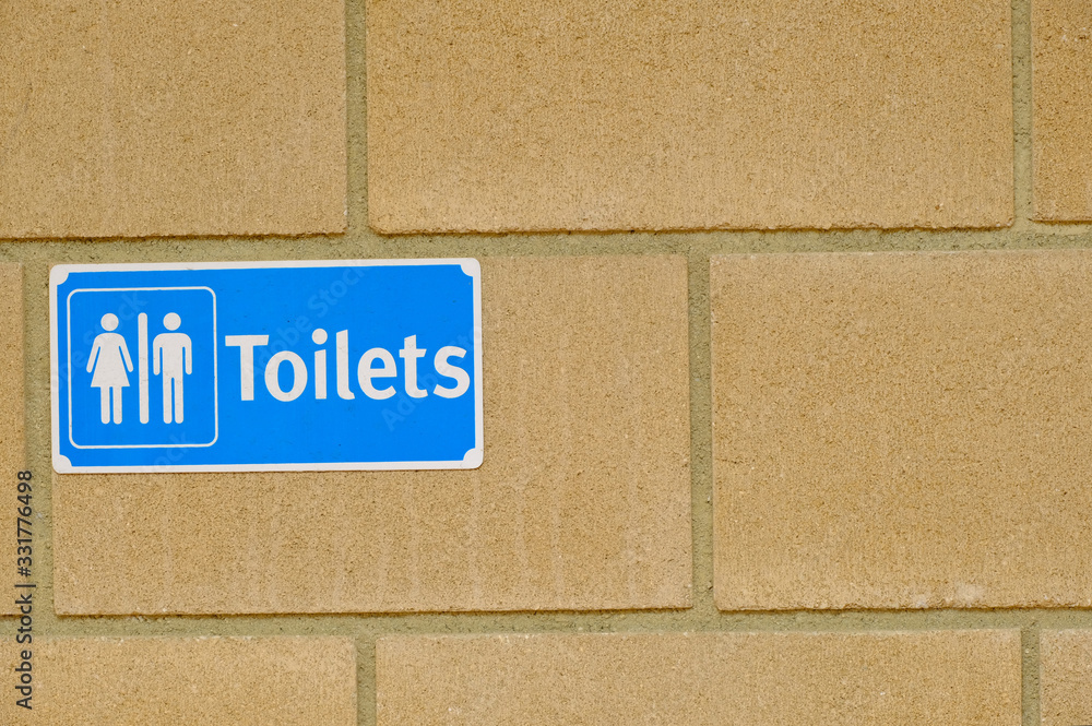 Public toilet sign for restroom with man and woman picture in blue ...