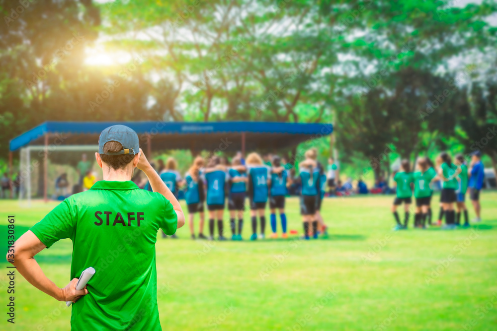 Staff coaches who stand to watch athletes compete on the side of the ...
