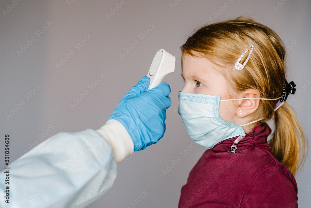Coronavirus. Nurse or doctor checks girl's body temperature using ...