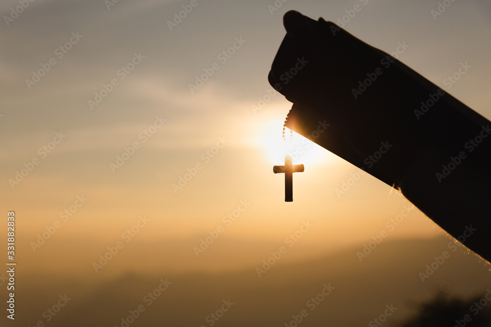 human hands praying to the GOD while holding a crucifix symbol with ...