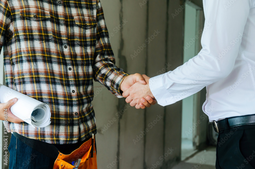 technician worker team contractor with blueprint handshake with ...