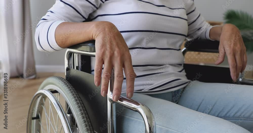 Close up retired elderly woman sitting in wheelchair alone at home ...