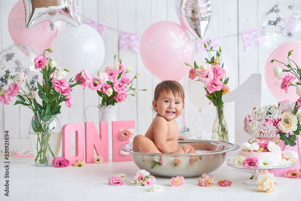 Smash cake party. Little cheerful birthday girl with first cake. Happy ...