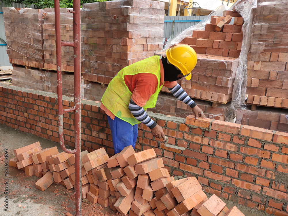 Brickwork by construction workers at the construction site. Workers ...