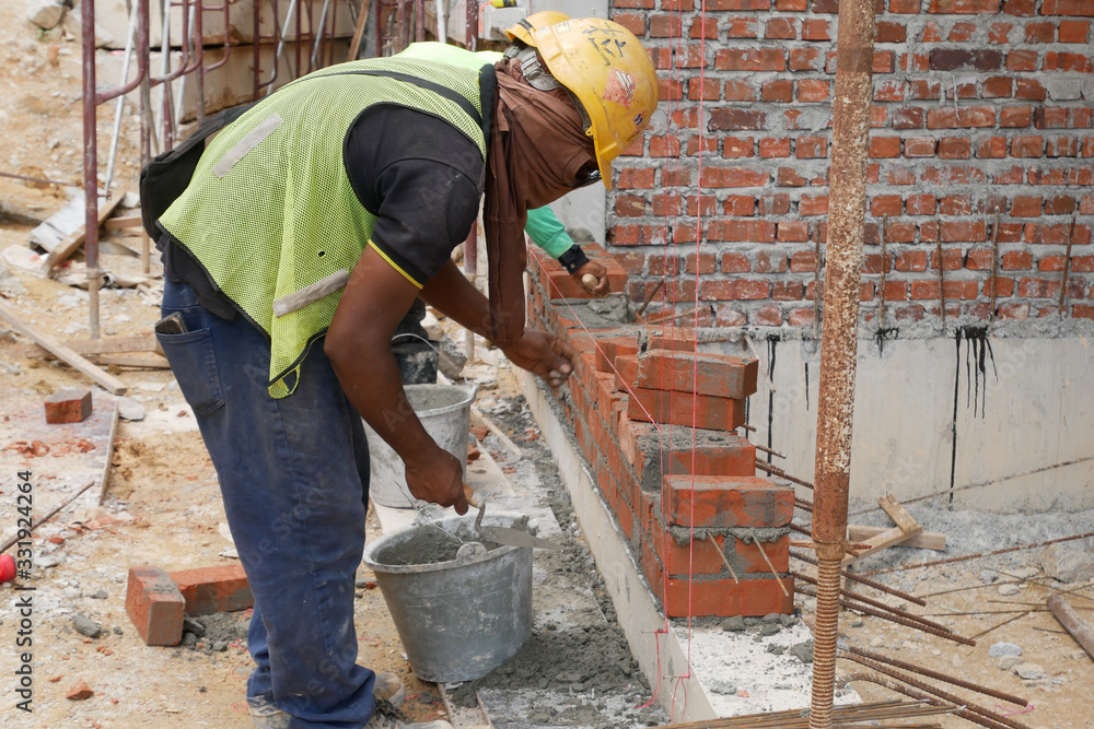 Brickwork by construction workers at the construction site. Workers ...