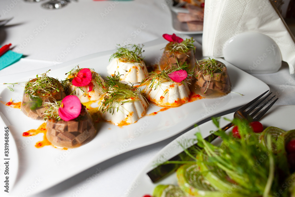 Calves-foot in the forms on the banquet table. Jellied meat on the ...