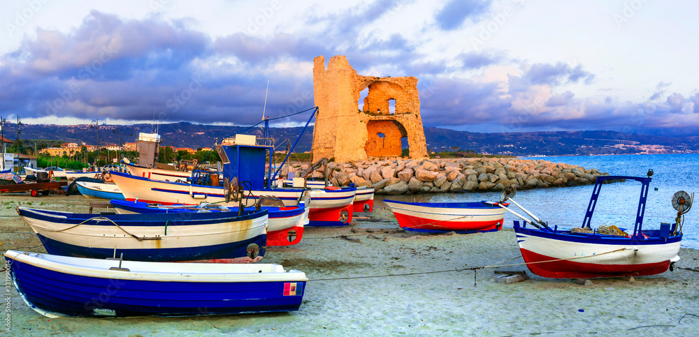 Picturesque old harbour with tradtional fishing boats and saracen tower ...
