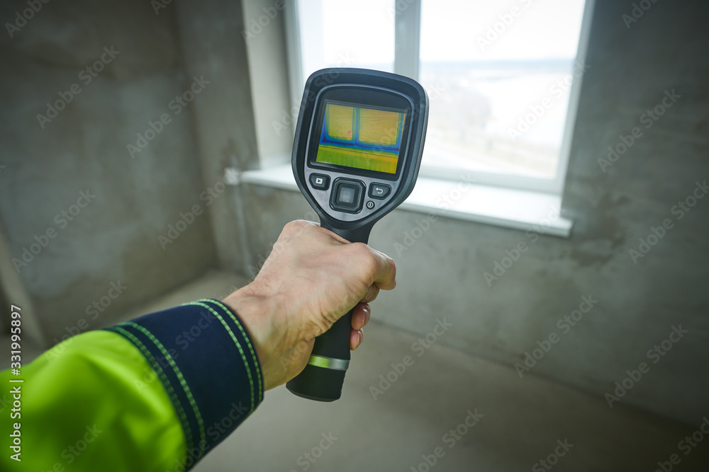 thermal imaging camera inspection of window building. check heat loss ...
