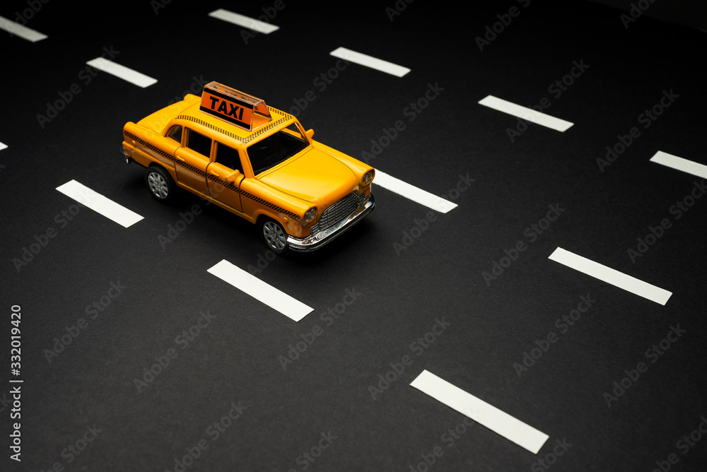 Top and front view of a yellow cab on an asphalt road with road lanes ...