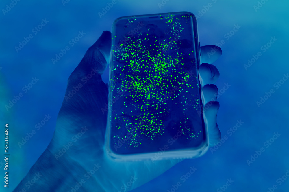 Dirty mobile phone screen with invisible germs shown in green contrast ...