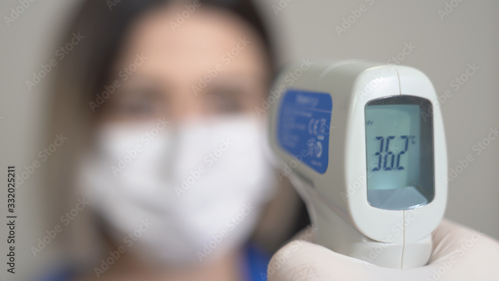 Taking woman 's temperature with thermometer to find infected by ...